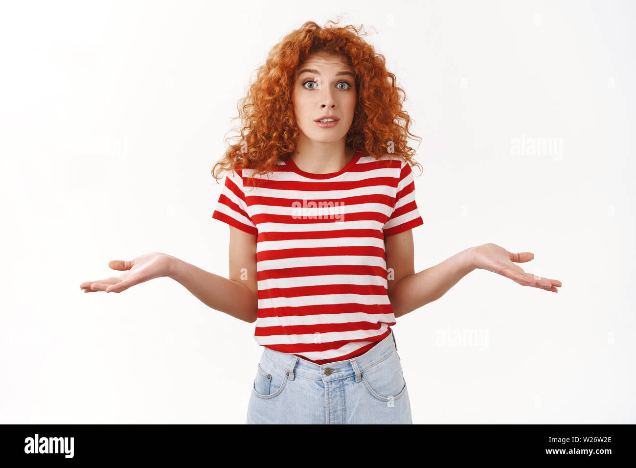 No idea. Confused doubtful attractive redhead curly woman looking ...