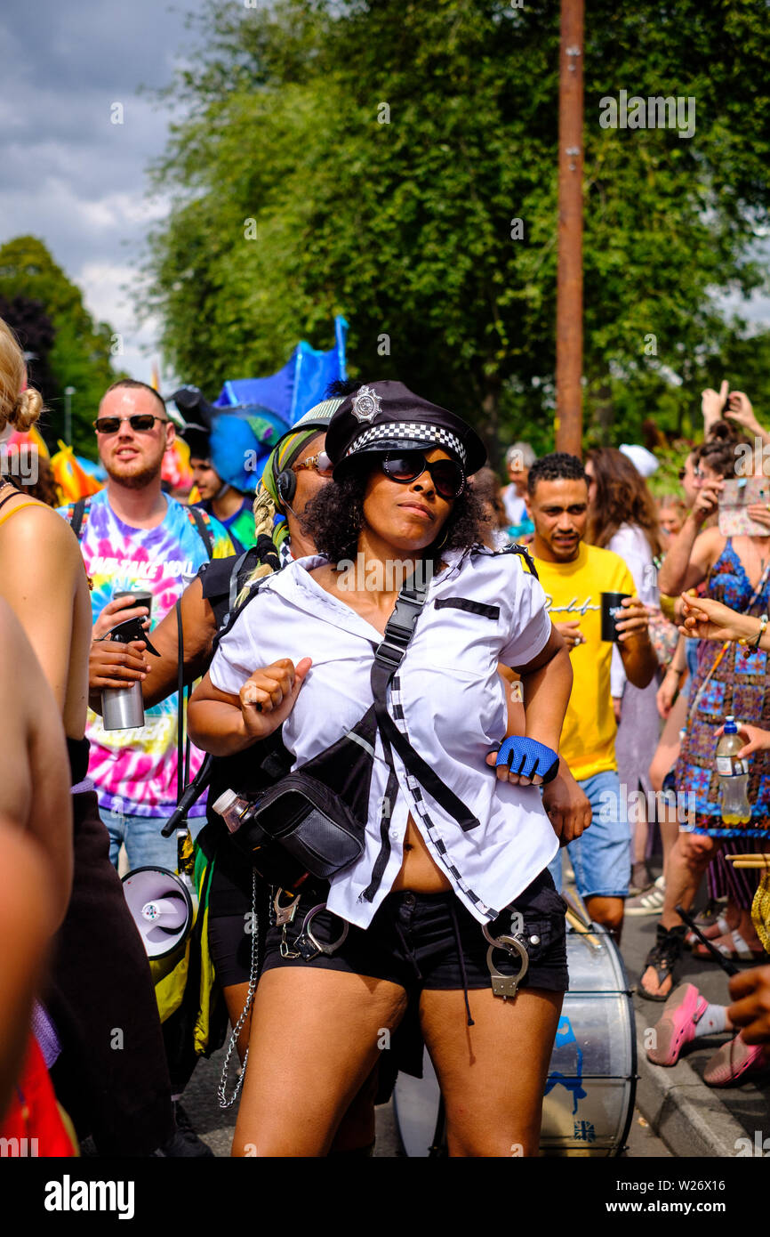 Female performer dressed as a police officer marching in the parade at ...