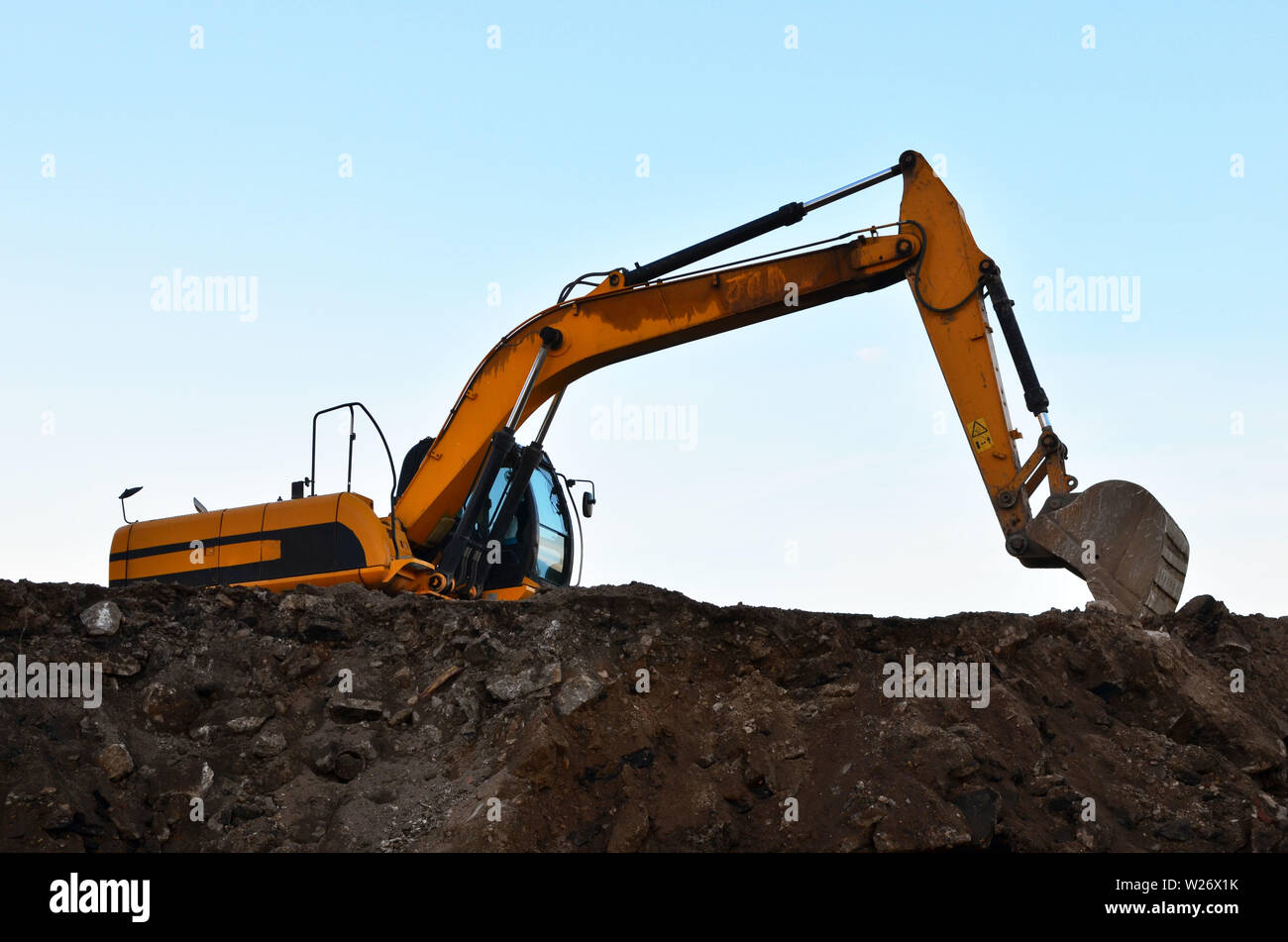 Heavy excavator working at construction site. Crushing and processing ...