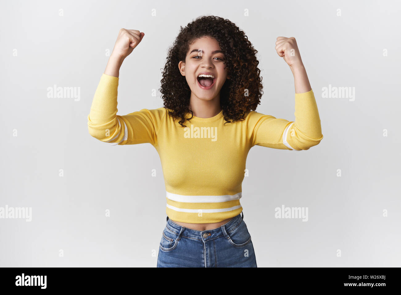 Yes go tigers. Charming cheerful girl yelling supportive devoted fan ...