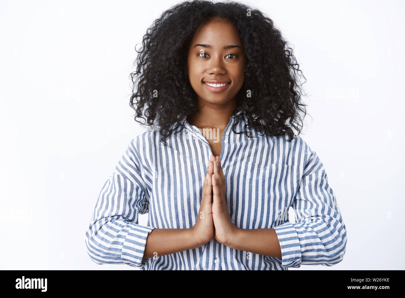 Portrait of faithful good-looking pleasant dark-skinned woman believe ...