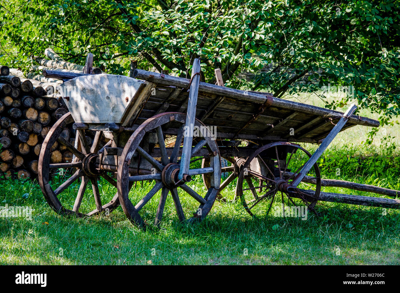 Vintage wooden cart against the background of a stack of firewood Stock ...