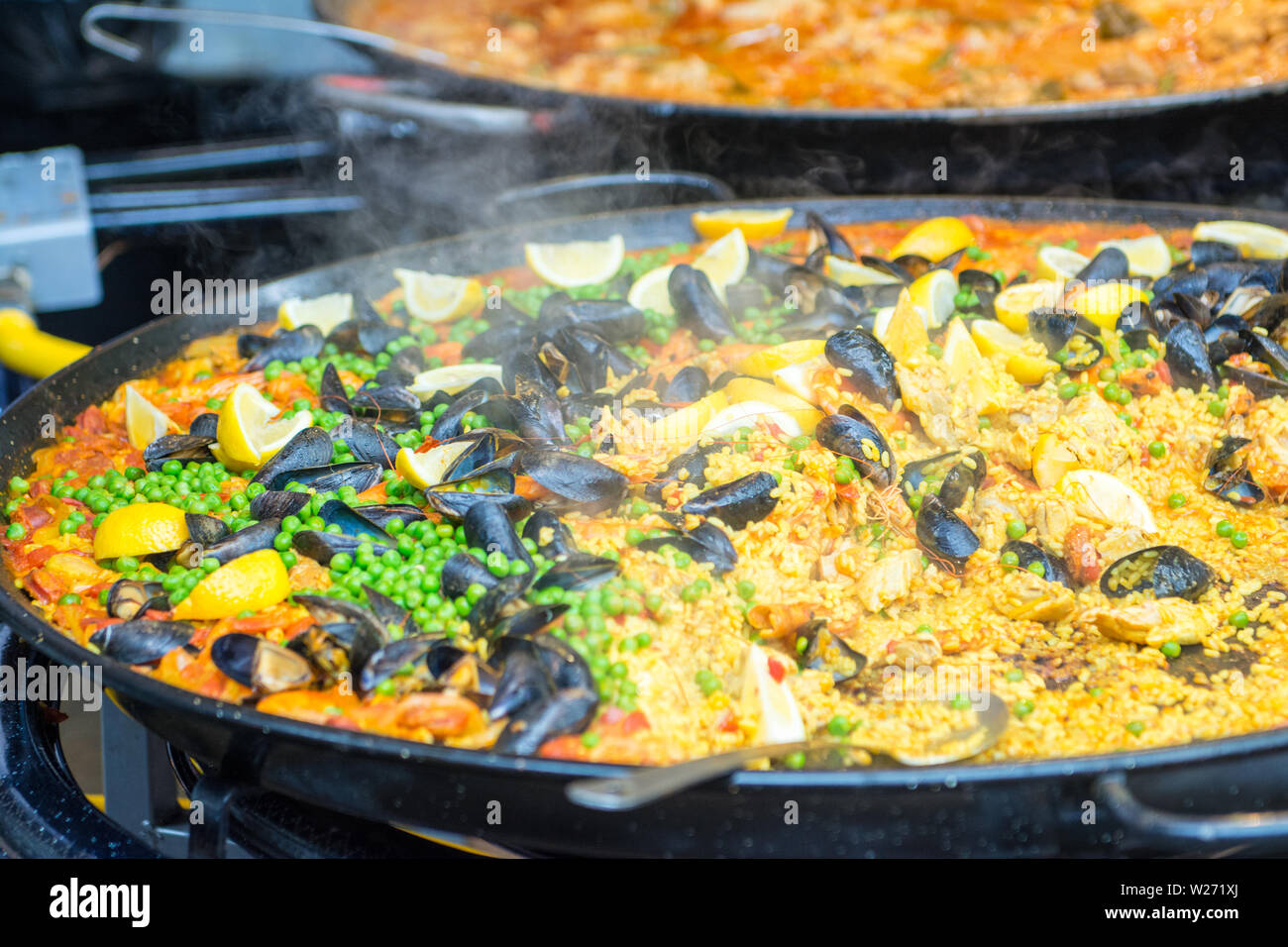 Display of steaming hot paella at local artisan market Stock Photo - Alamy