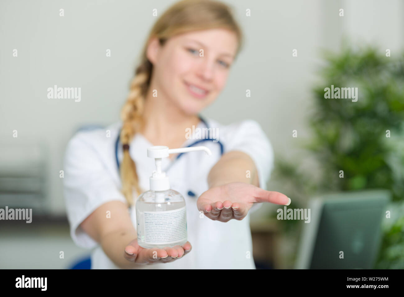 nurse holding forwards an antibacterial pump dispenser Stock Photo - Alamy