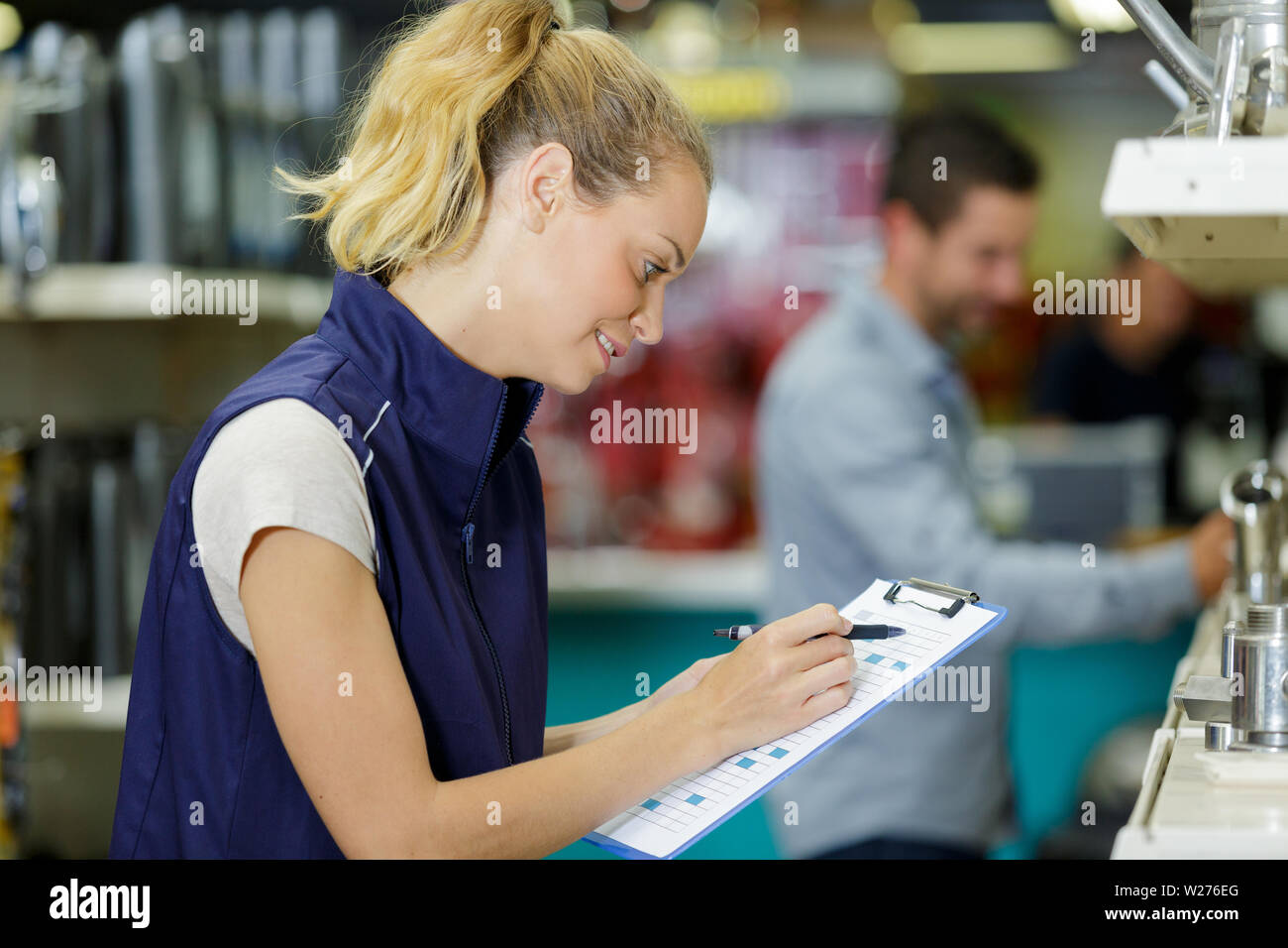 female worker in hardware store Stock Photo - Alamy