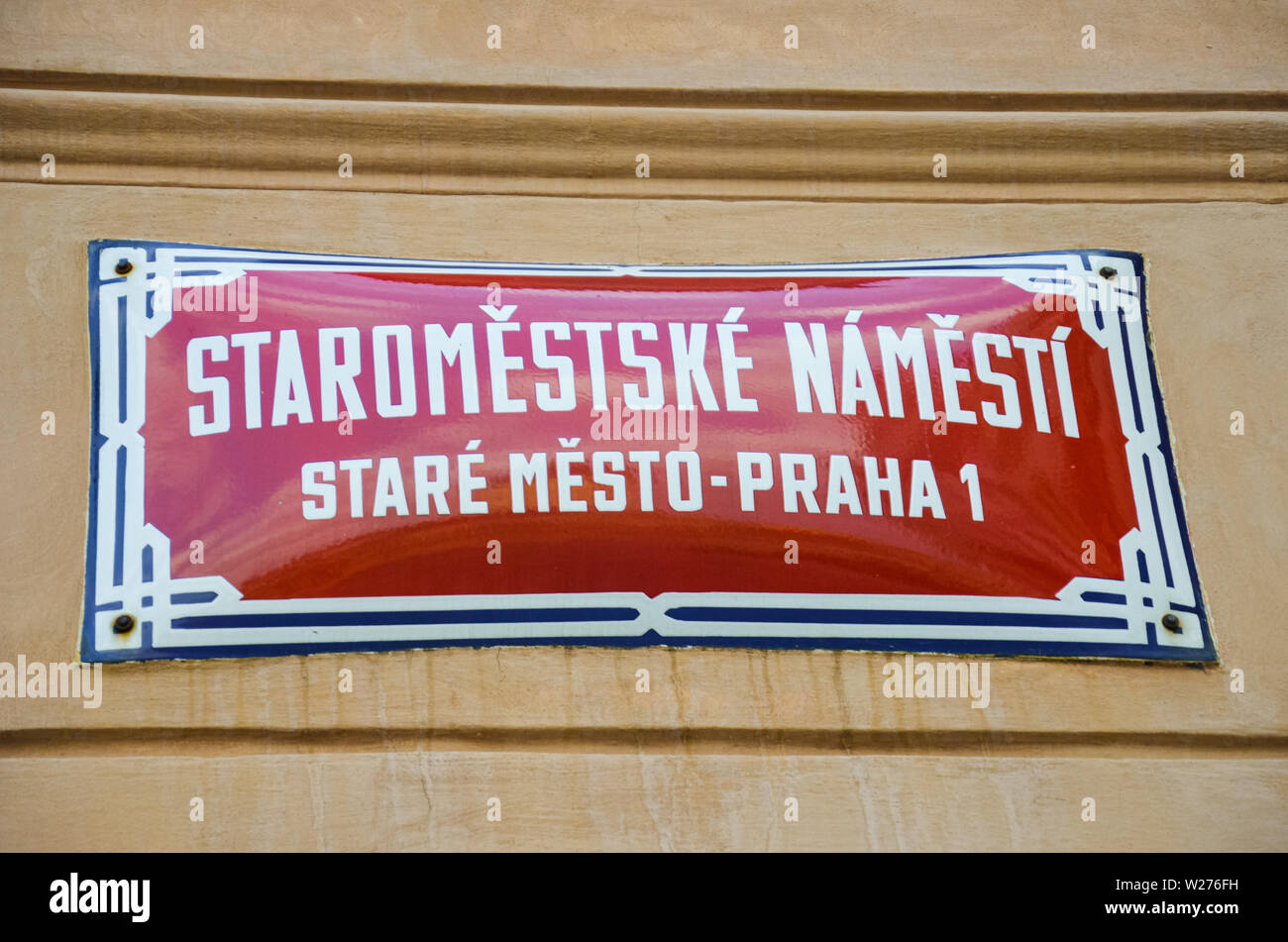 Red street sign in Prague, Czech Republic with white text: Old Town ...