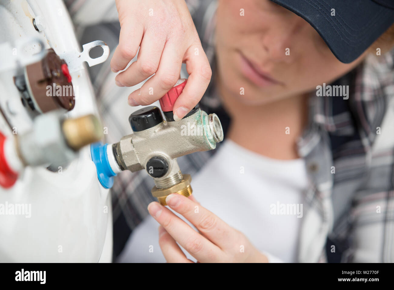 female technician fixing gas tap Stock Photo - Alamy
