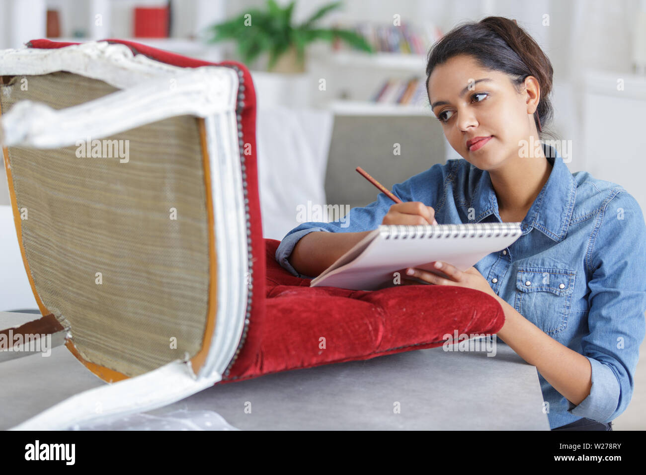 woman taking notes before upholstering a chair Stock Photo - Alamy