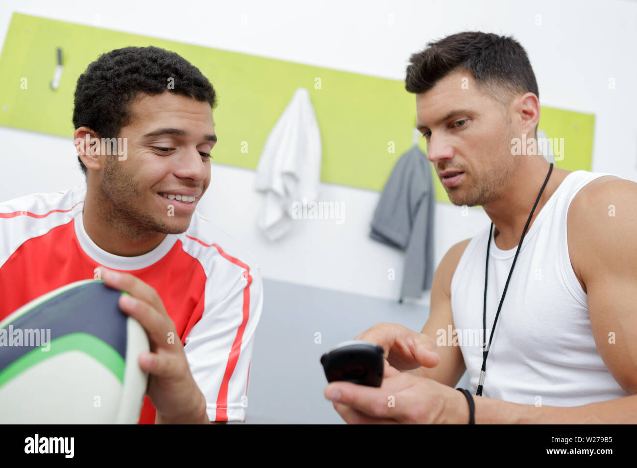 rugby coach and player in locker-room Stock Photo - Alamy