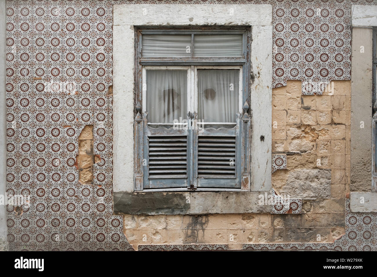 Gray window shutters and grunge wall background Stock Photo - Alamy