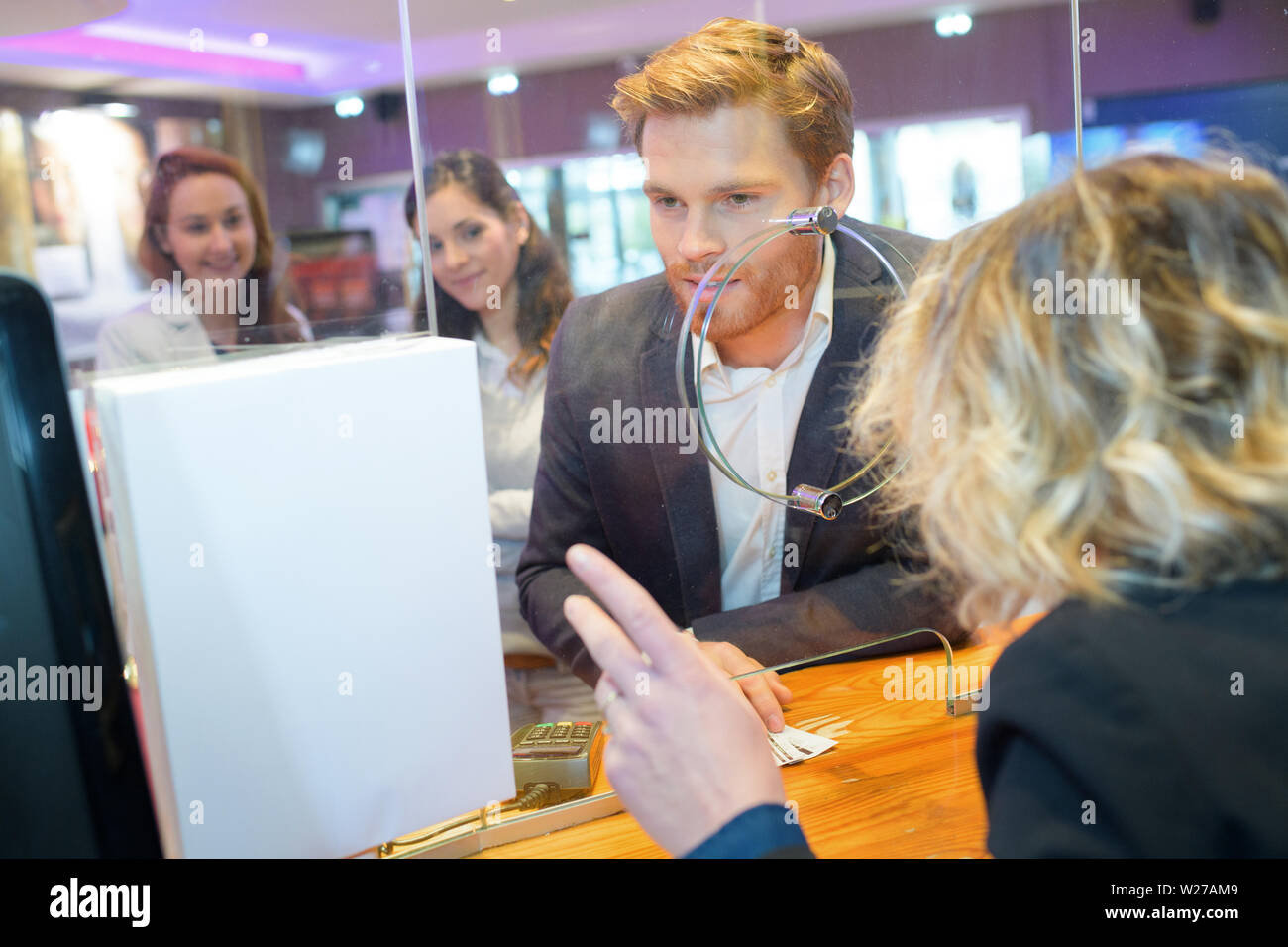 man buying cinema tickets Stock Photo - Alamy