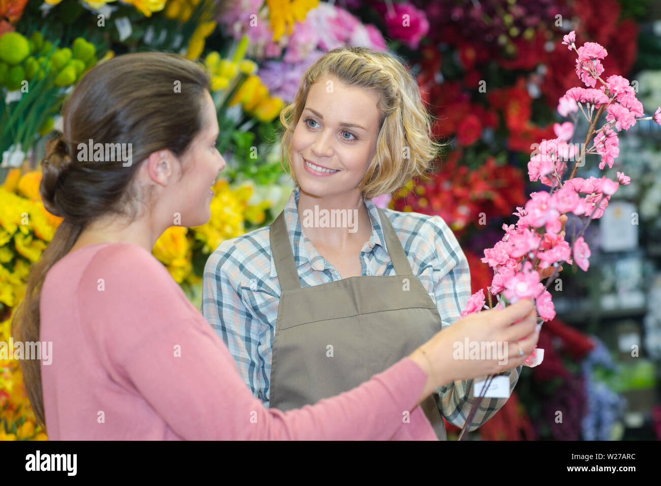 young smiling woman selecting plastic flowers Stock Photo - Alamy