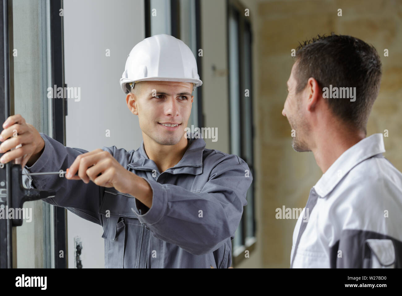 window with door glazing installer apprentice Stock Photo - Alamy