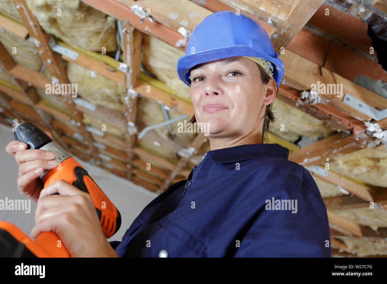 portrait of female construction worker using cordless drill Stock Photo ...