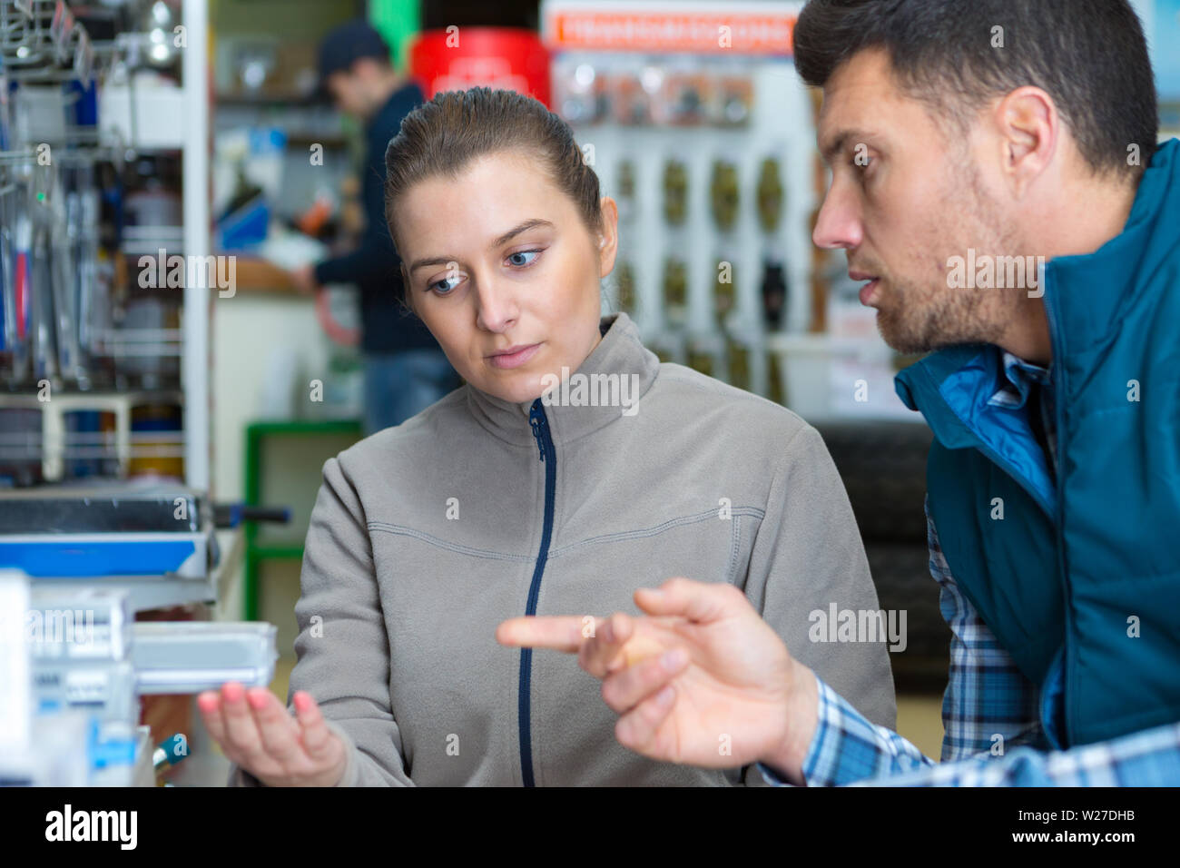 sales assistant helping customer in warehouse store Stock Photo - Alamy