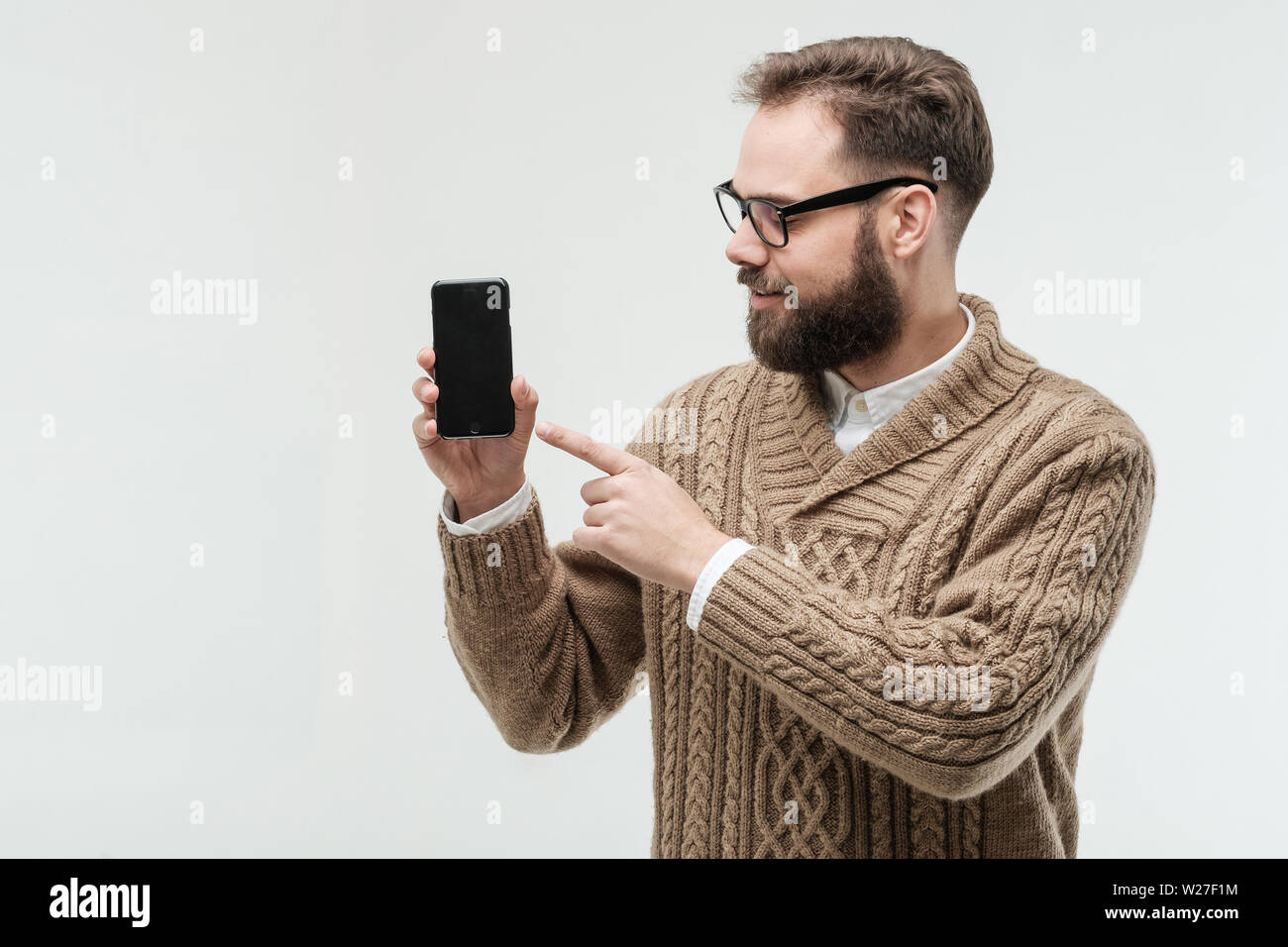 Young man tap on screen of his phone Stock Photo - Alamy
