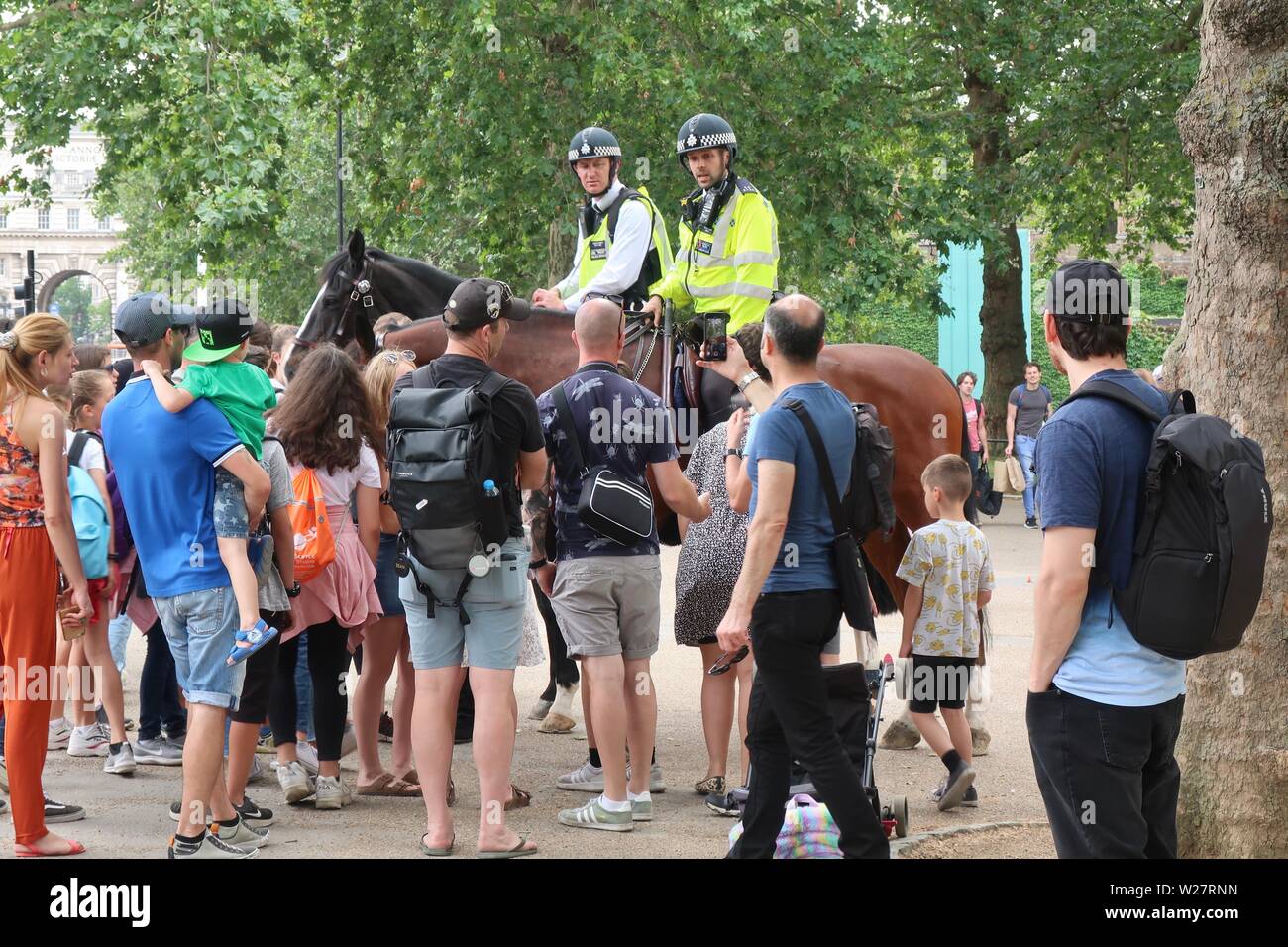 London, UK - 6 July 2019: Mounted police chat with people on The Mall ...
