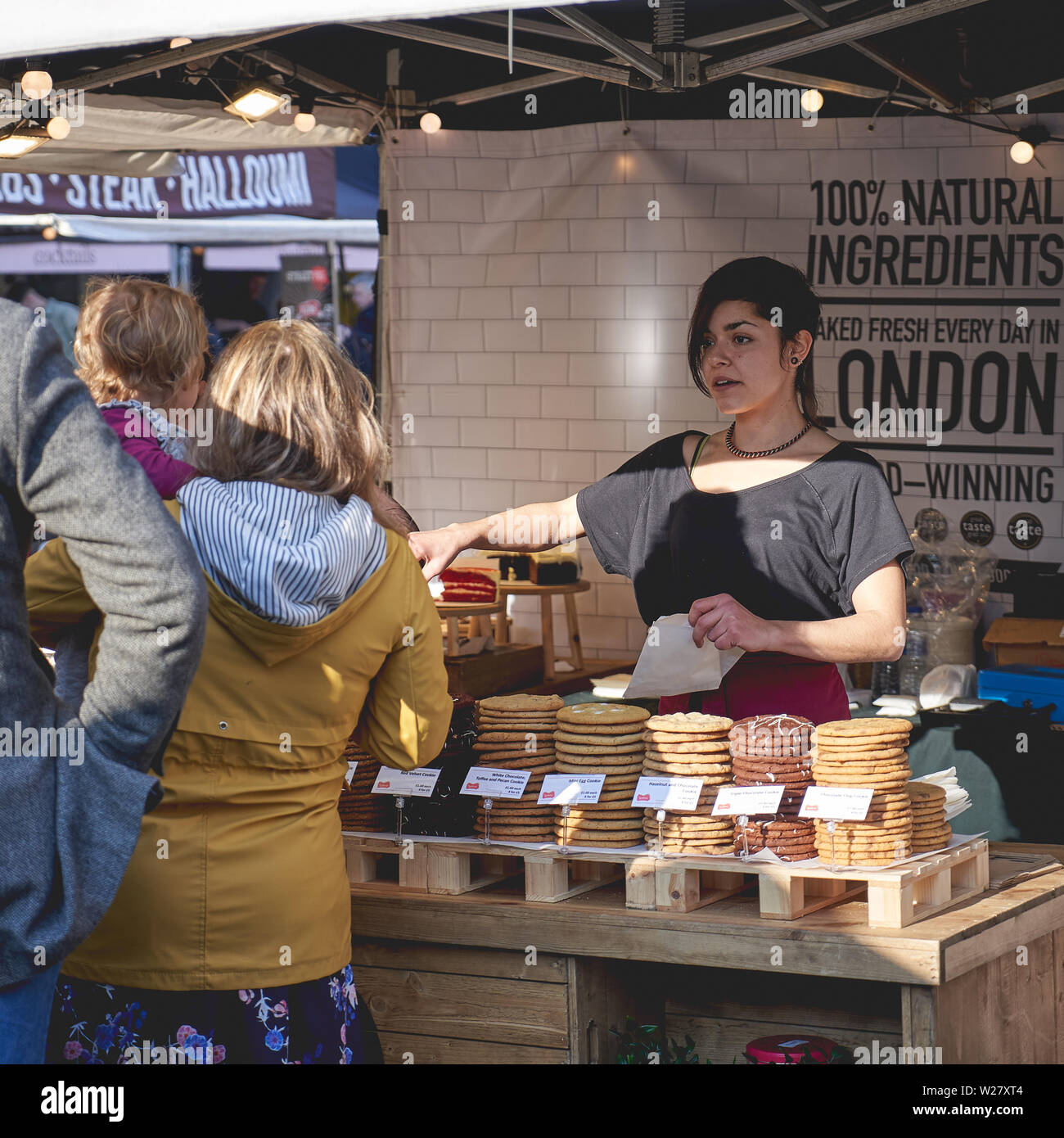 London, UK - March, 2019. A street food stall selling cookies in a food ...