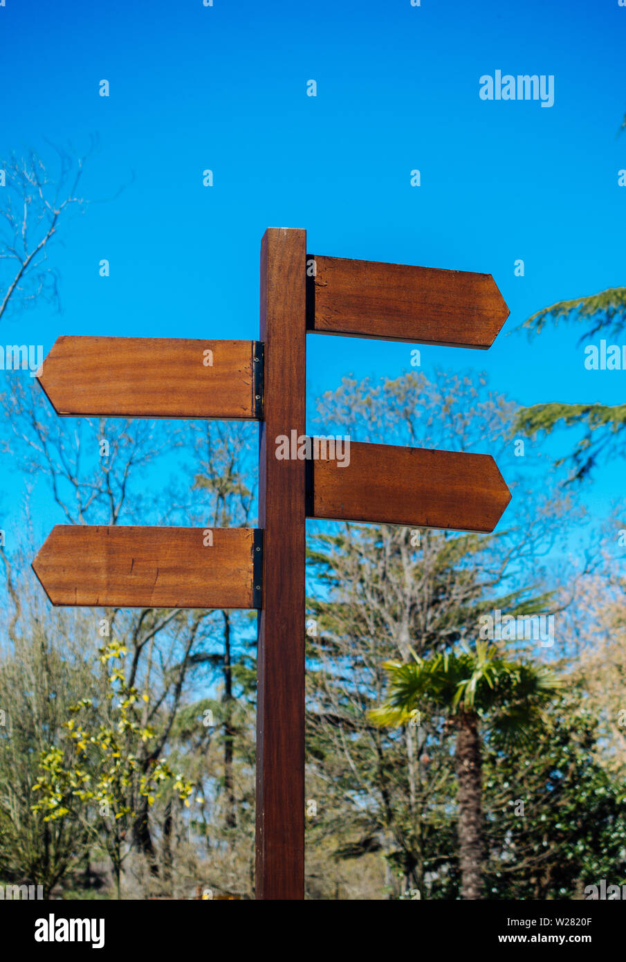 Wooden post for road signs placed in garden Stock Photo - Alamy