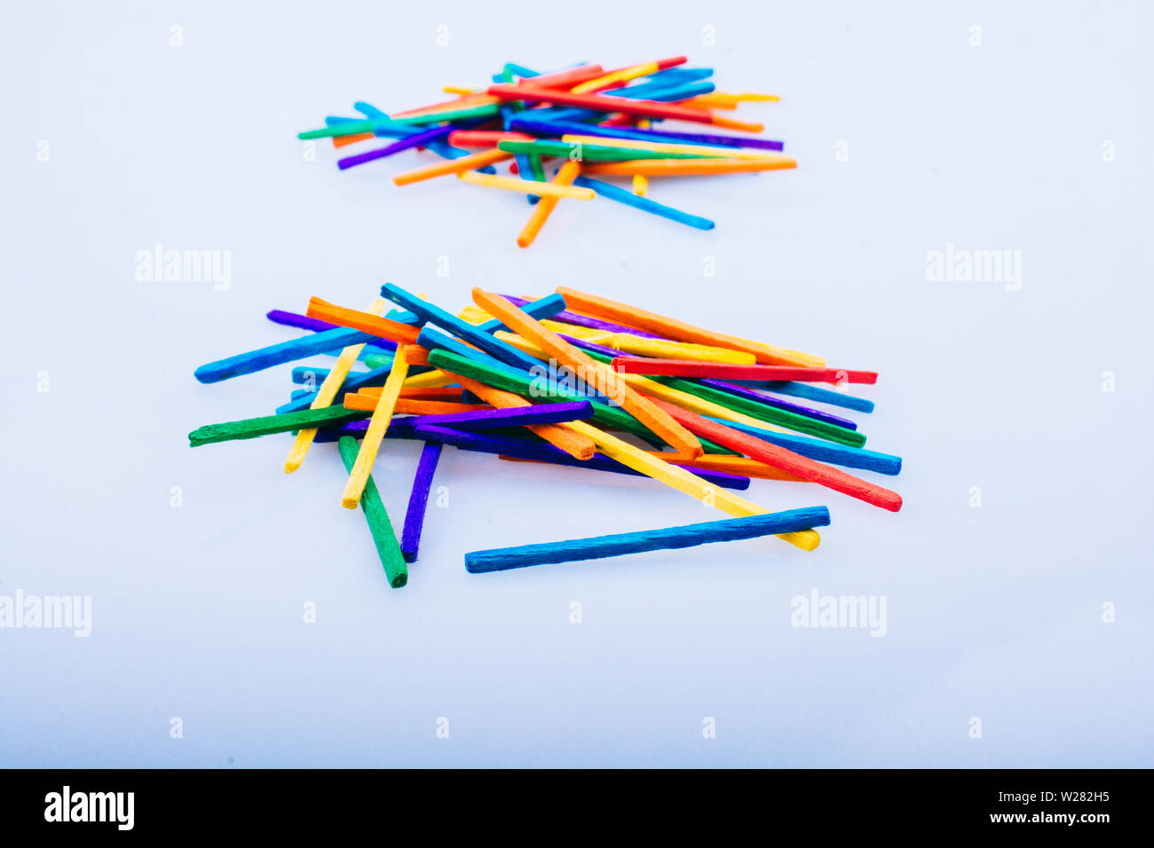 Beautiful coloured wooden sticks for creativity on black background ...