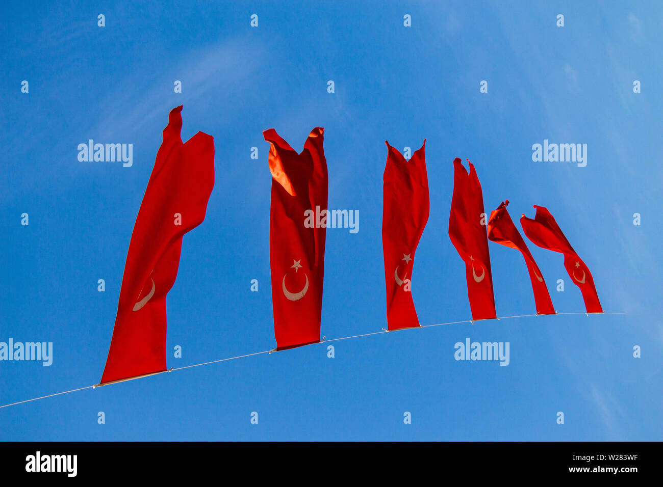 Turkish national flags with white star and moon in sky Stock Photo - Alamy