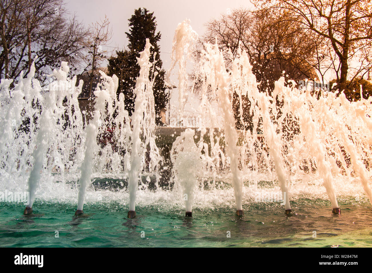 A water fountain sprinkling water in the view Stock Photo - Alamy