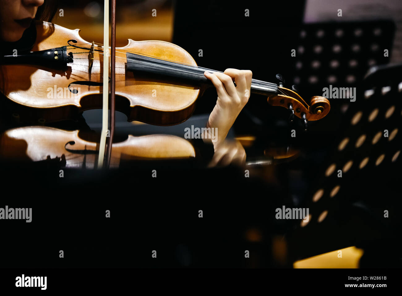 Woman fiddler during a concert, background in black Stock Photo - Alamy