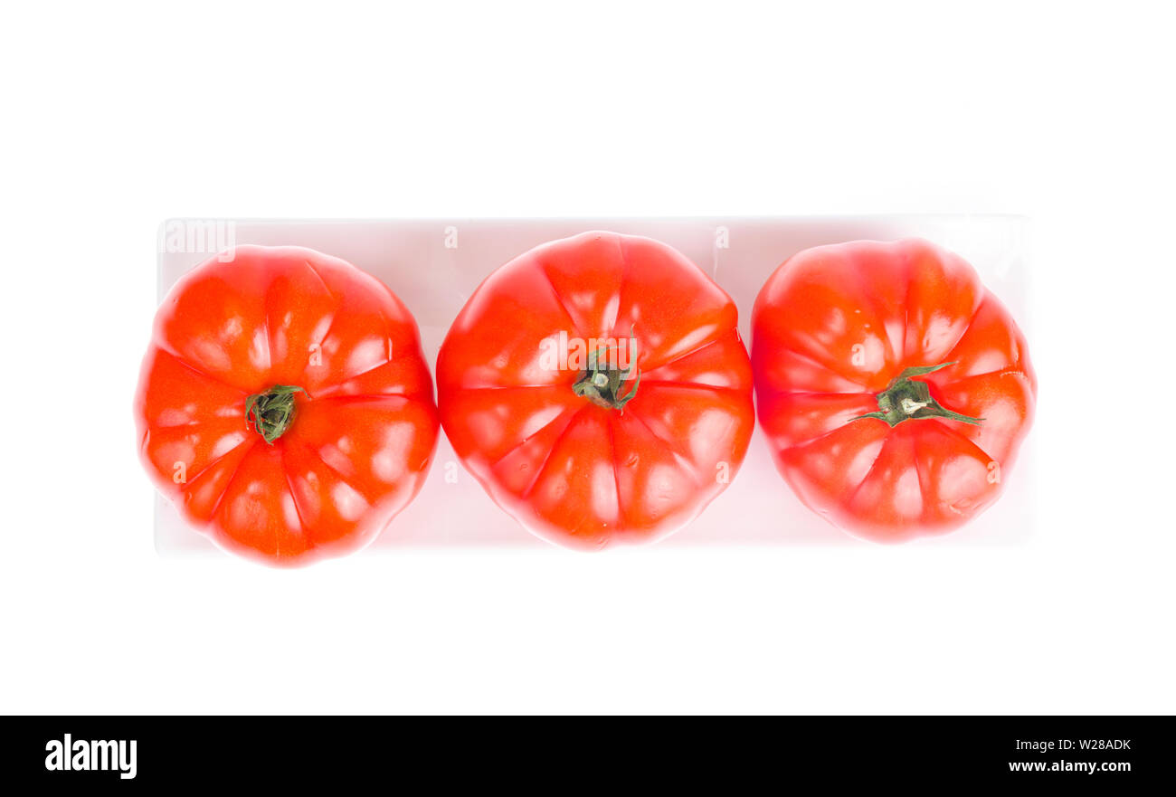 Three red ripe tomato beef. Studio Photo Stock Photo - Alamy