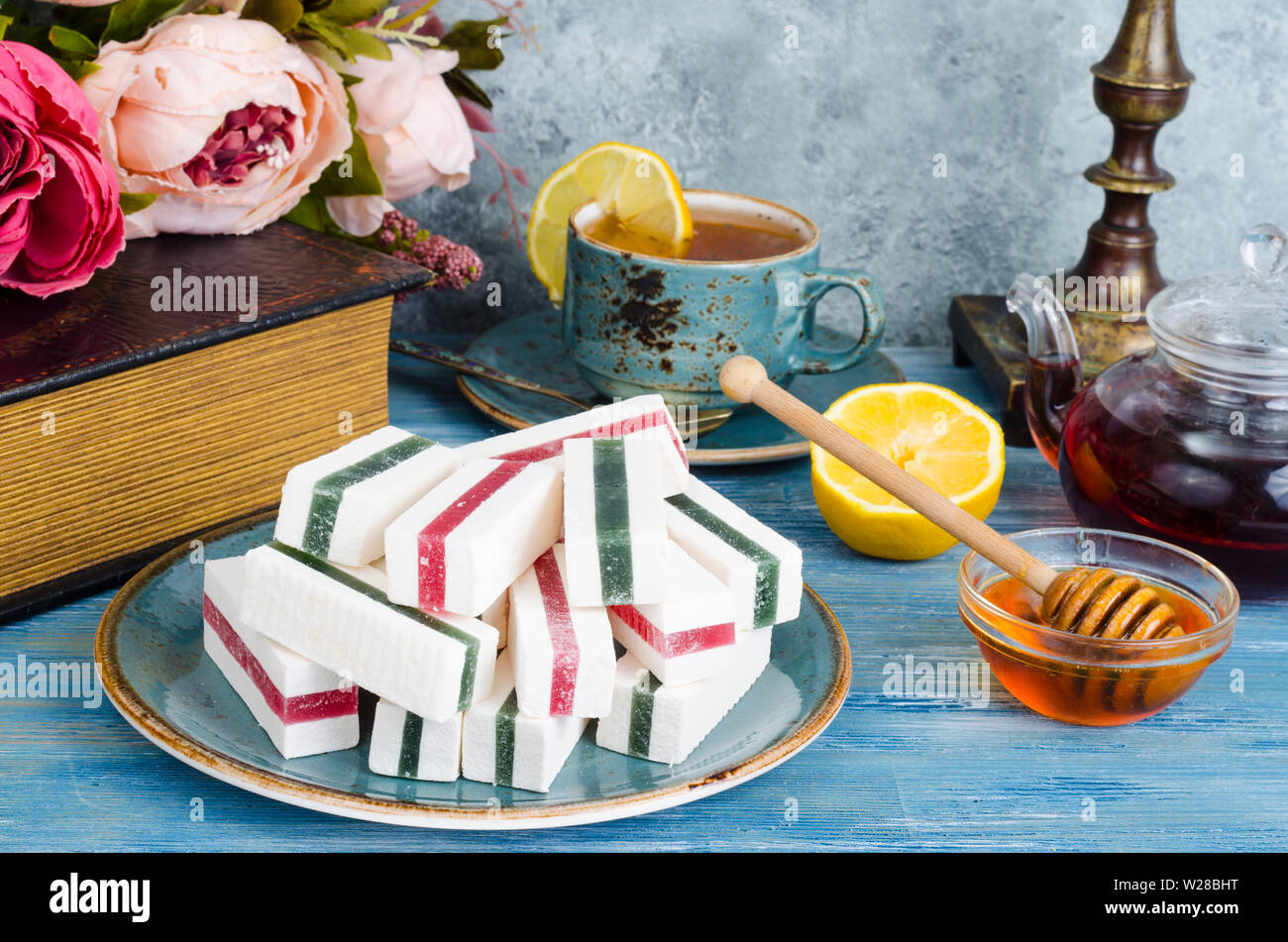 Composition on table with marshmallows, cup of tea Stock Photo - Alamy