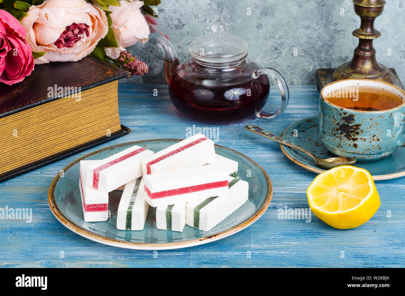 Composition on table with marshmallows, cup of tea Stock Photo - Alamy