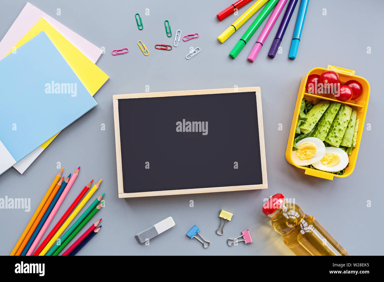 School supplies and lunch box with sandwich and vegetables. Back to ...