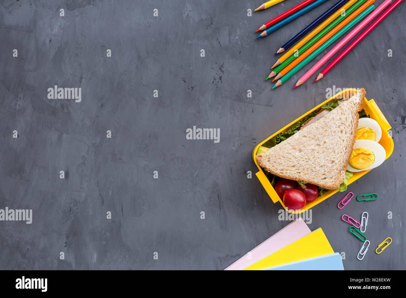 School supplies and lunch box with sandwich and vegetables. Back to ...