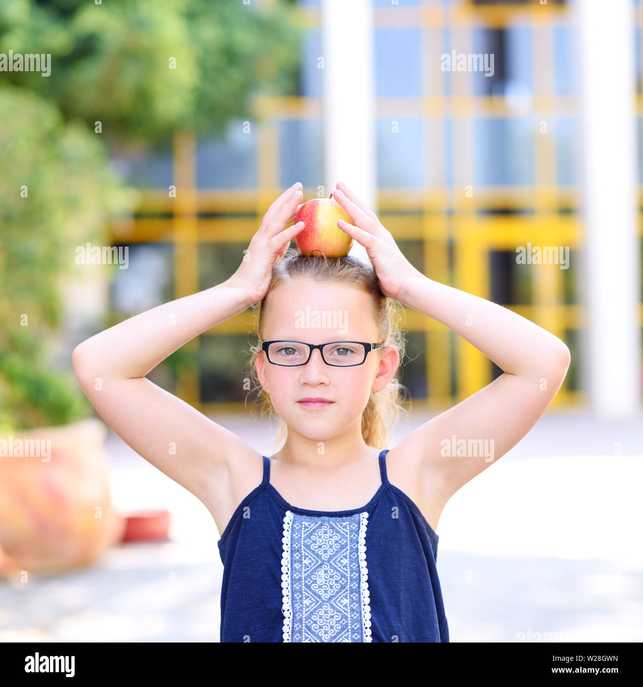 Happy Girl In Glasses With Apple on Her Head. Great Portrait Of School ...