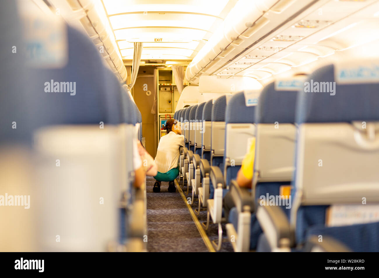 Flight attendant sitting hi-res stock photography and images - Alamy