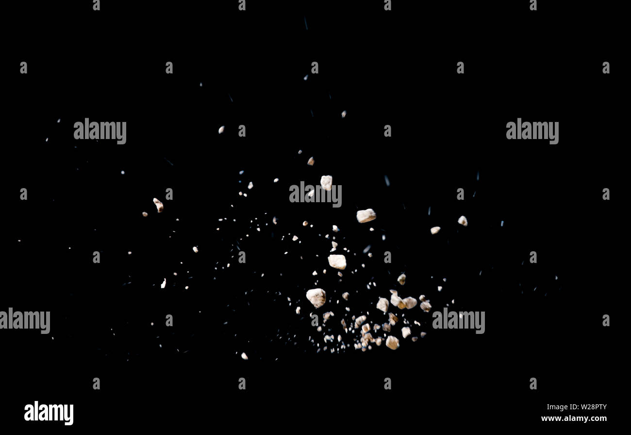 Break stone caused by explosion against black background Stock Photo ...