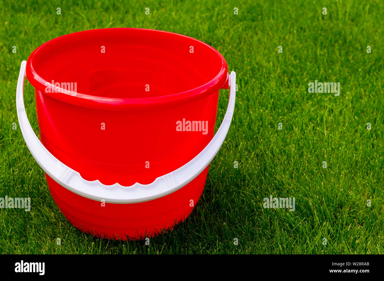 Colored plastic garden buckets on background of green grass Stock Photo ...