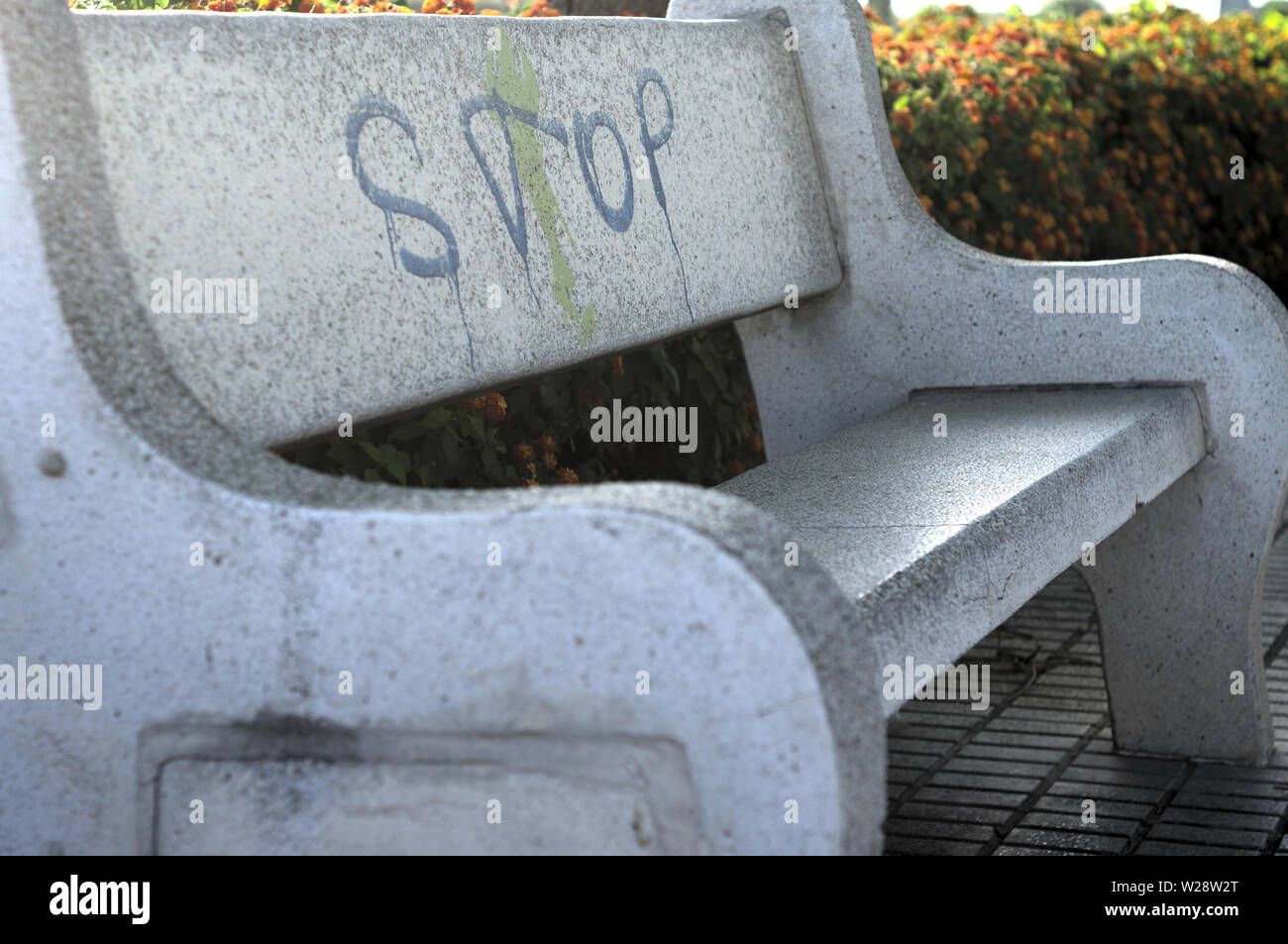 white stone bench with a painted that invites you to sit down Stock ...