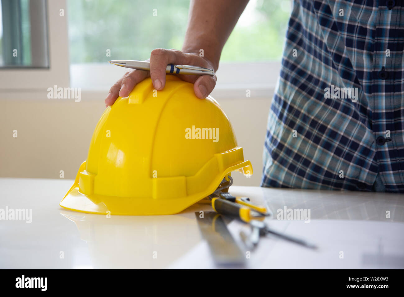 architect man handwriting with blueprint to build houses. After ...