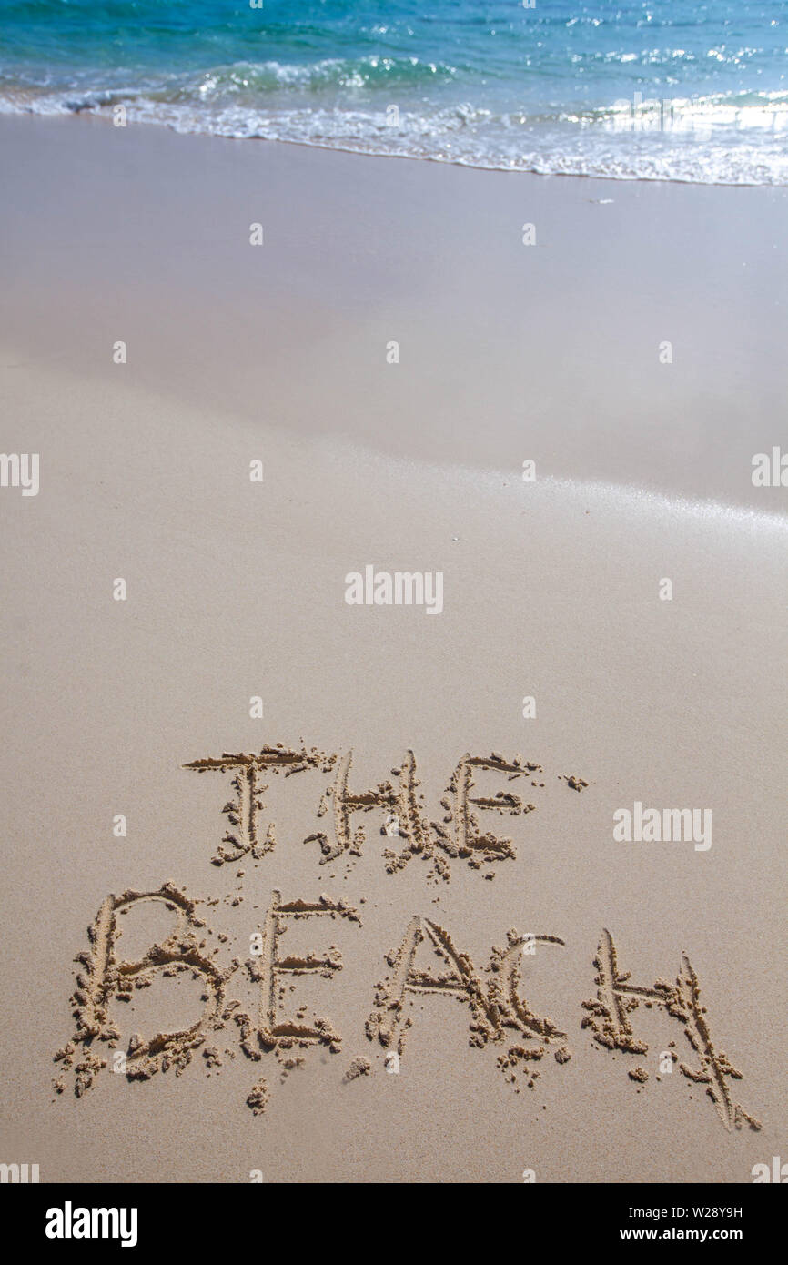 The beach words writing on tropical sea beach Stock Photo - Alamy