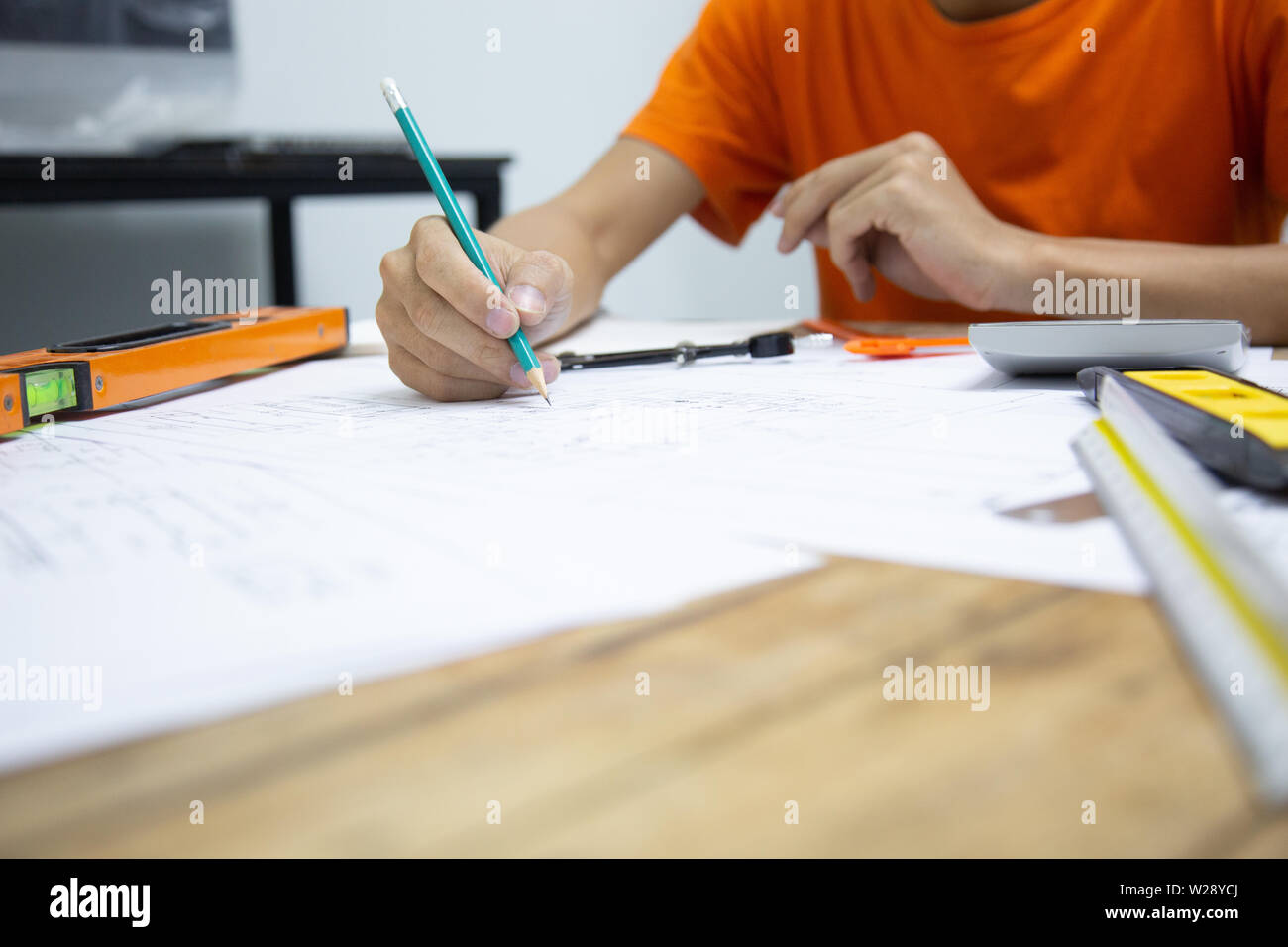 Architect Designing in blueprint at Construction Site With drawing ...