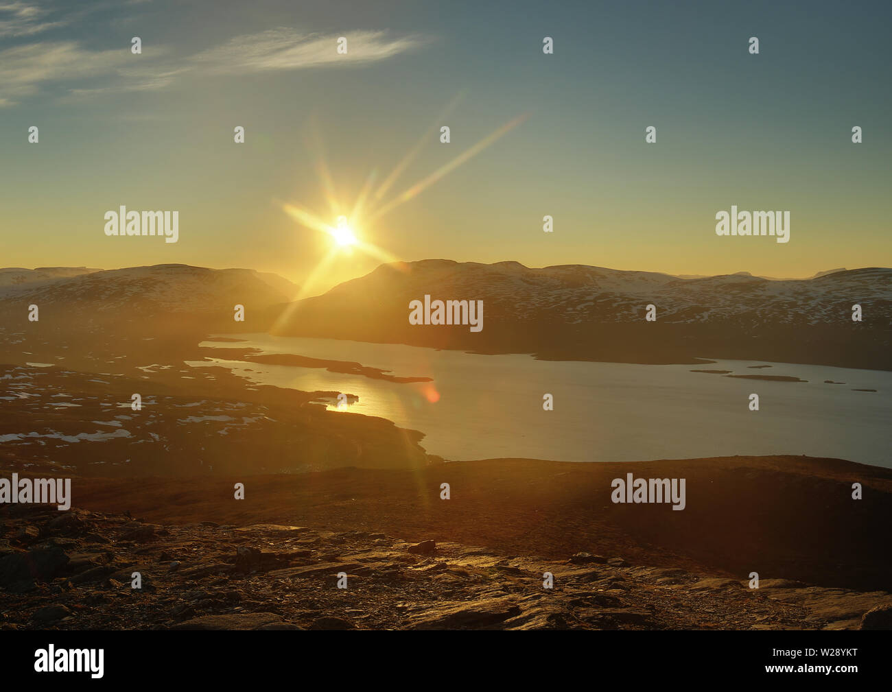 HDR of midnight sun seen from the peak of Nuolja in Northern Sweden ...