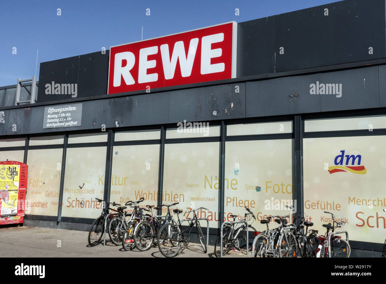 Logo REWE supermarket, bicycles outside shop store supermarket, Berlin ...