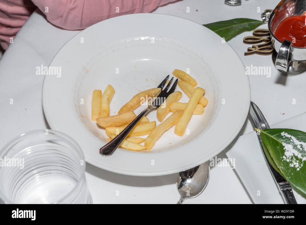Half empty plate with french fries of a child, Germany Stock Photo - Alamy