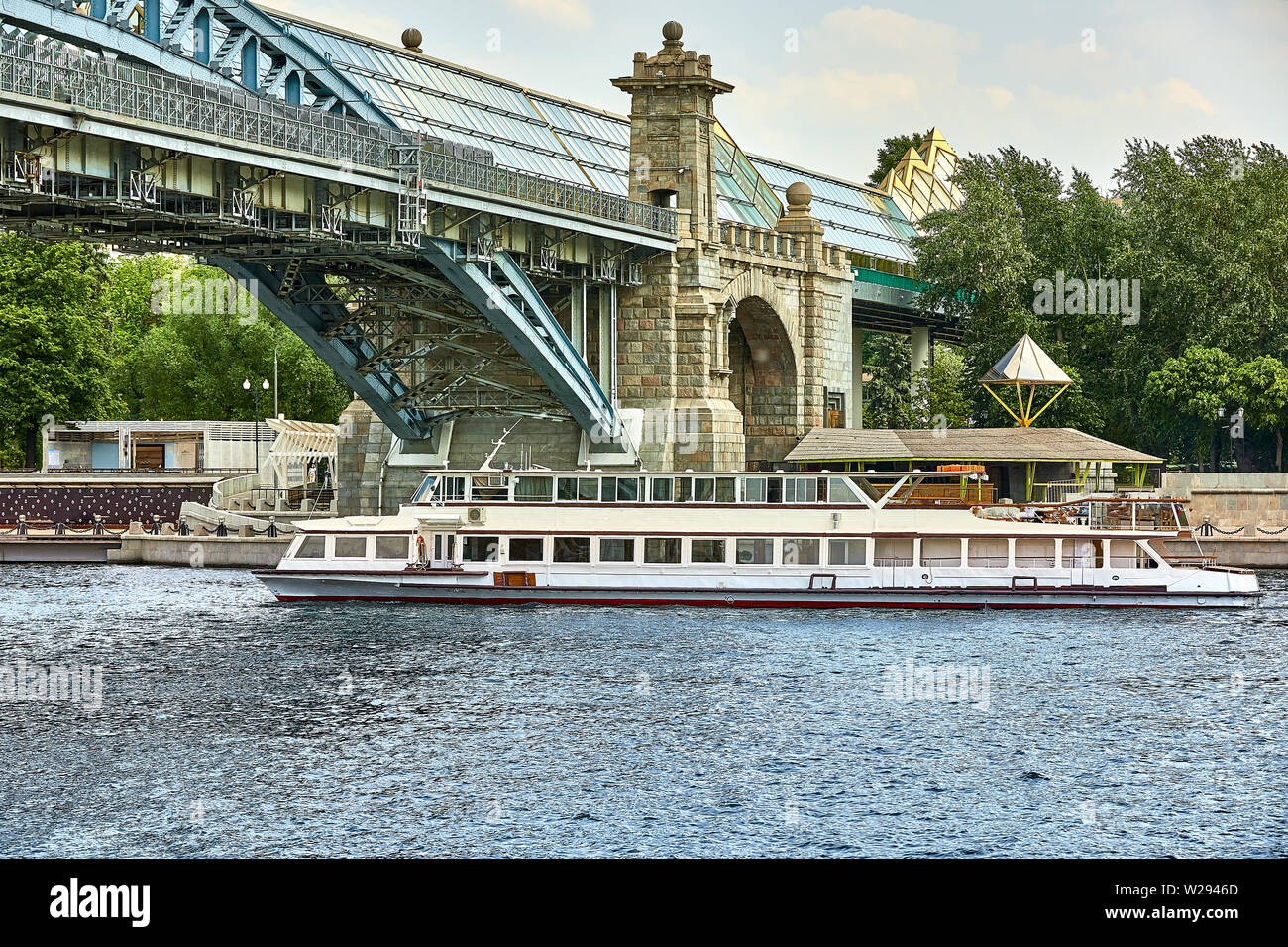 Modern river ship on the background of the bridge in the city. The ship ...