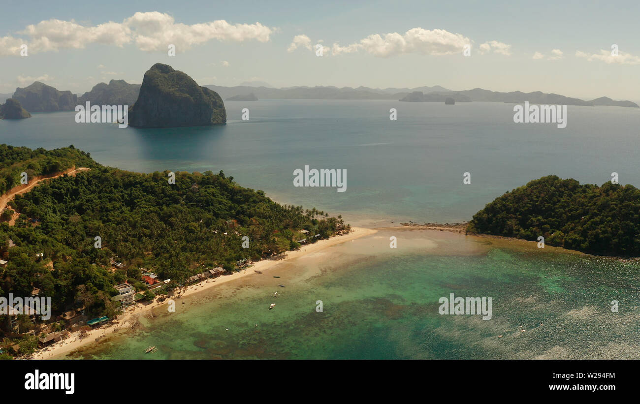 Tropical sandy beach and blue water, aerial view. Las Cabanas, El Nido ...