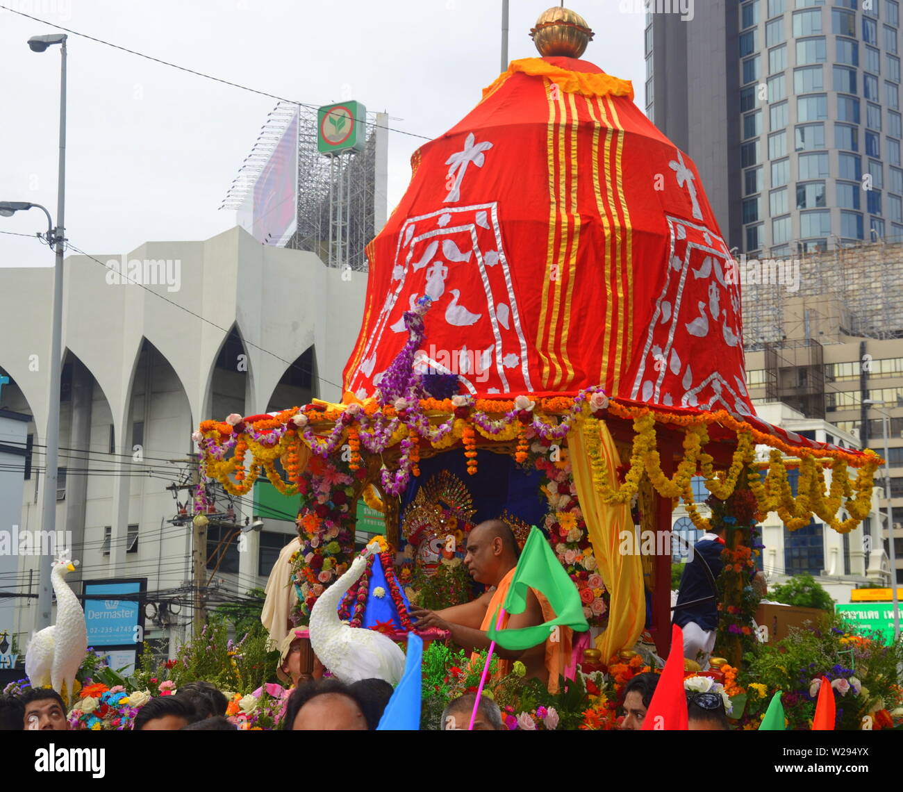 An elaborate float decorated with flowers in a colourful parade by The ...
