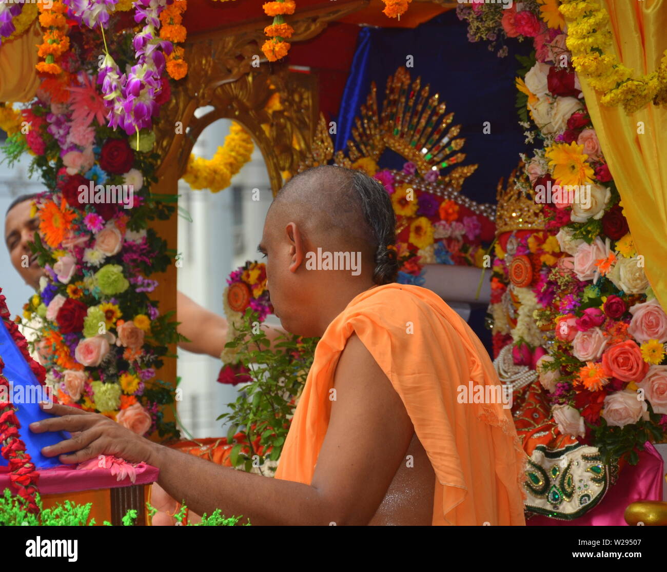 An elaborate float decorated with flowers in a colourful parade by The ...
