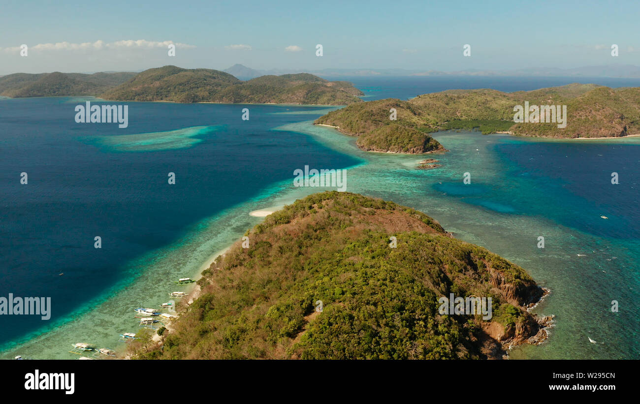 Tropical islands with blue lagoons, coral reef and sandy beach, aerial ...