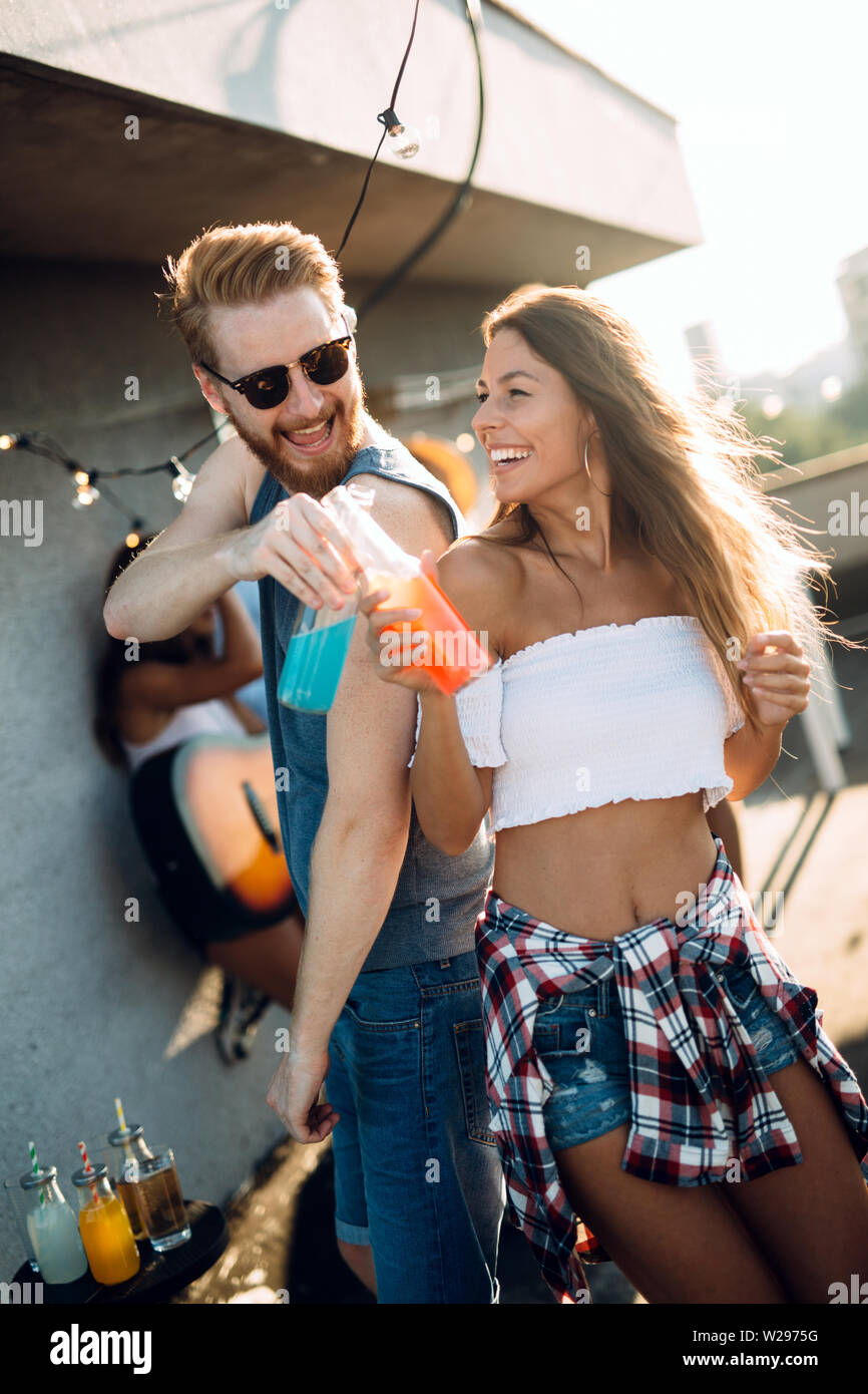 Happy couple having fun time at party Stock Photo - Alamy