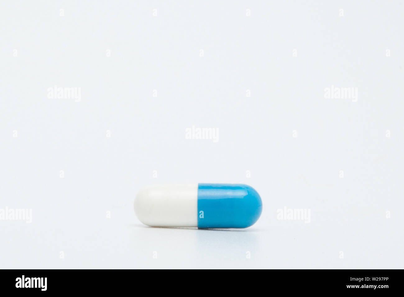 Macro view of blue capsule pill isolated over white background Stock ...